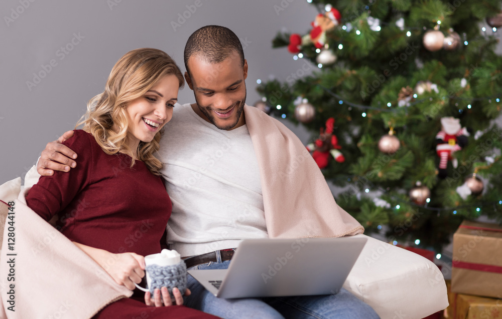Cute happy couple cuddling up on the sofa Stock Photo | Adobe Stock