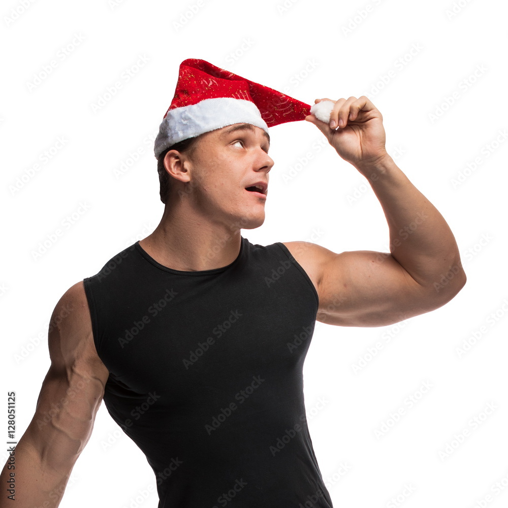 athlete bodybuilder posing with a beard and a cap of Santa Claus on a ...