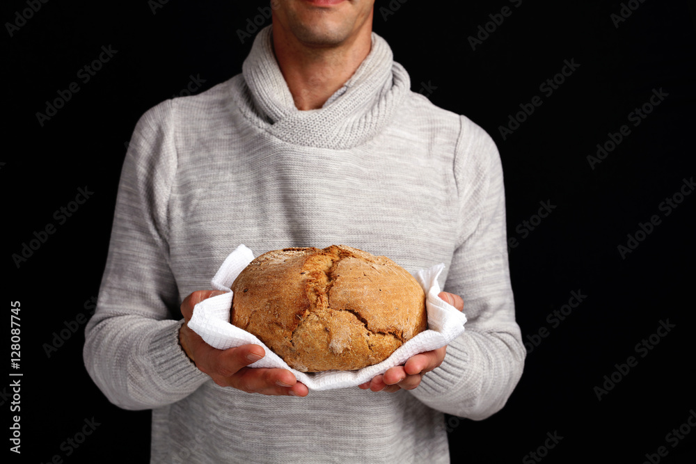 Man holding or giving bread as a welcome. Baker offer loaf of tasty ...