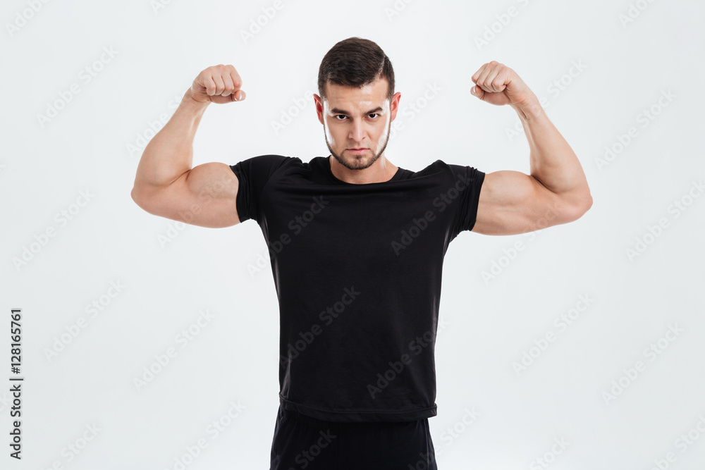 Muscular athlete showing his biceps Stock Photo | Adobe Stock