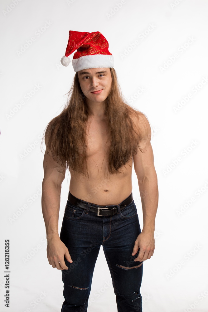 athlete bodybuilder shirtless with long hair posing in cap Santa Claus ...