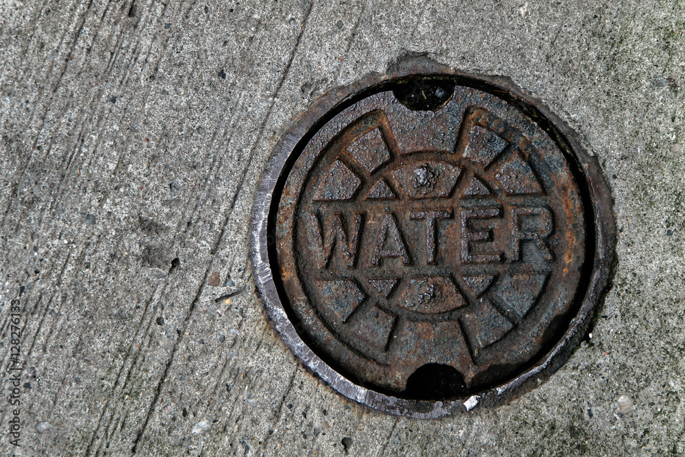 Water supply manhole cover. Access point to water main. Stock Photo ...