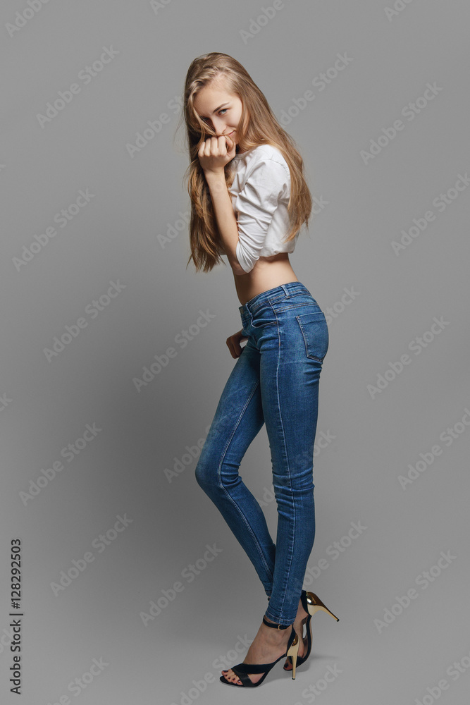 Attractive fashion model with long slim legs in jeans posing and Stock ...