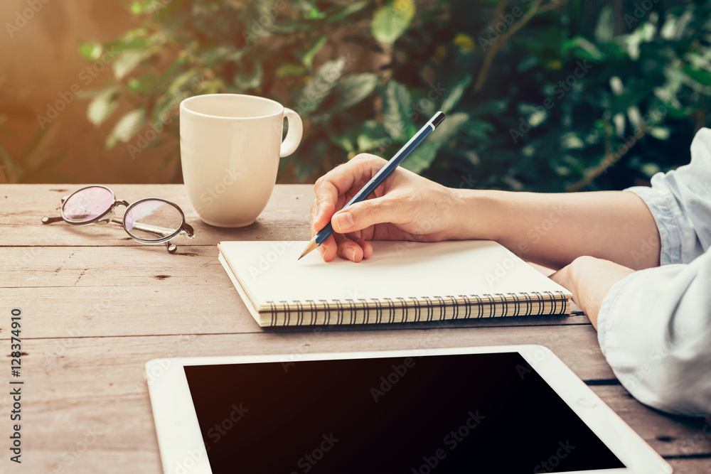 Young business woman hand with pencil writing on notebook. Woman Stock ...