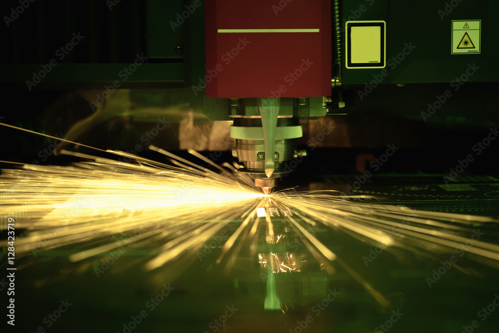 Cutting of sheet metal process with safety glass protection. Sparks fly ...