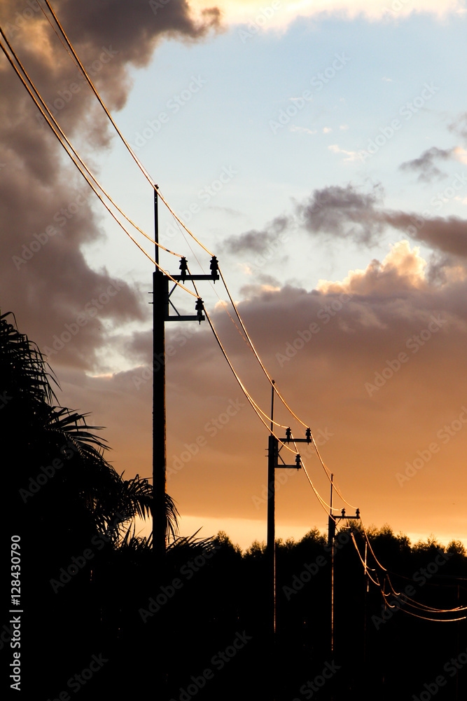 Silhouette power electric pole in evening time , sunset sky and ...