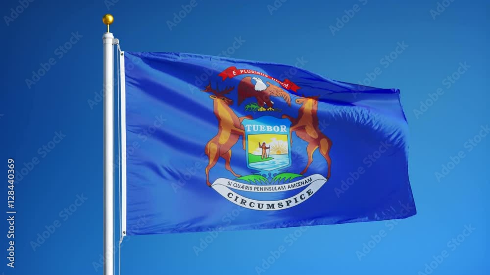 Michigan (U.S. state) flag waving in slow motion against blue sky ...