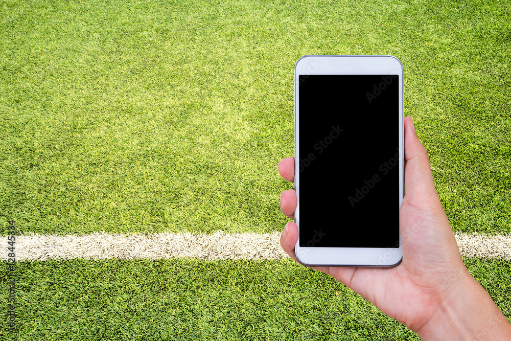 Hand holding mobile smart phone with football stadium screen. Stock ...