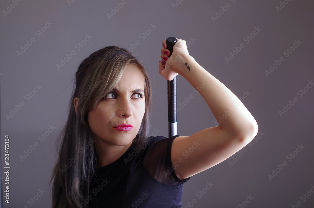 Samurai woman dressed in black clothes holding arm over shoulder ...