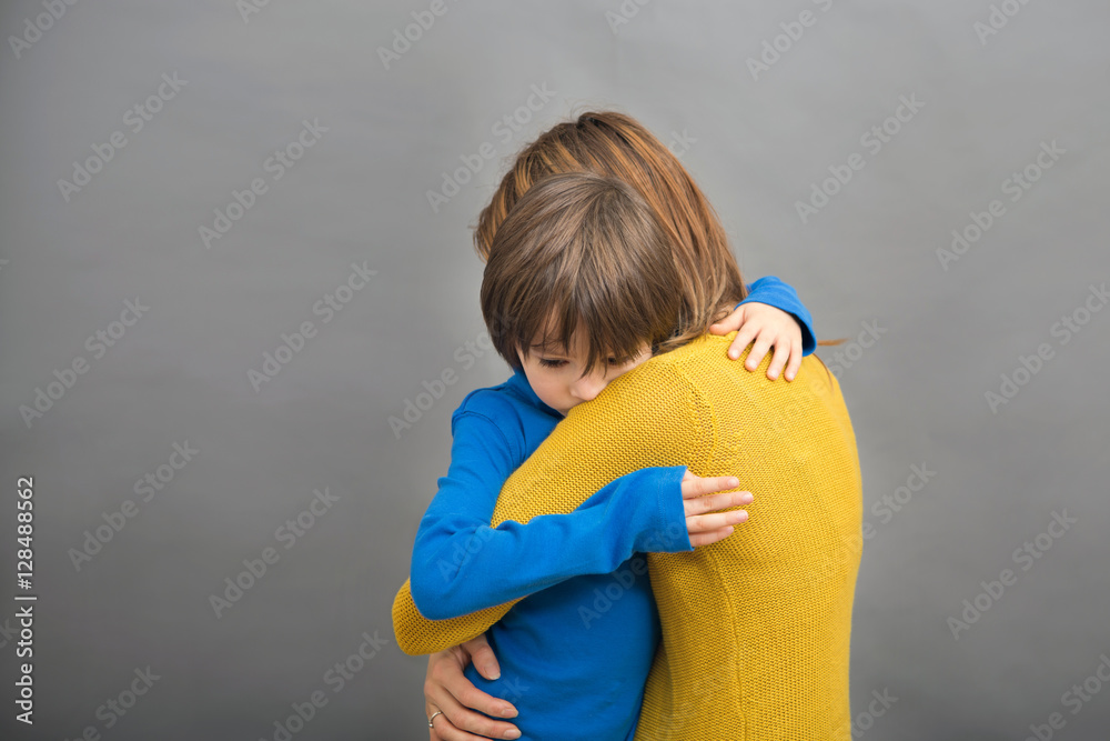 Sad little child, boy, hugging his mother at home, isolated imag Stock ...