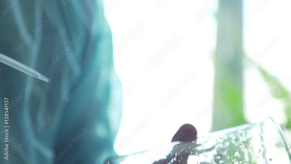 Close-up of washing chemical test tubes with a special solution ...