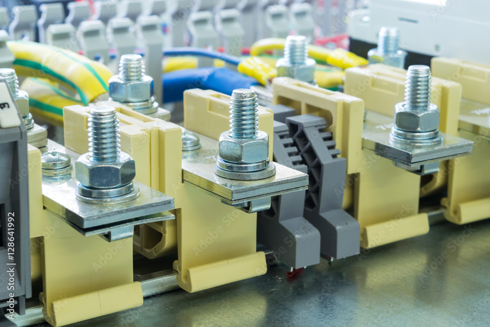 beige bolt bushing terminals on the DIN rail located on the mounting ...