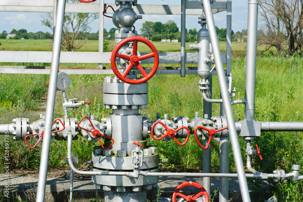 wellhead in the oil and gas industry. Stock Photo | Adobe Stock