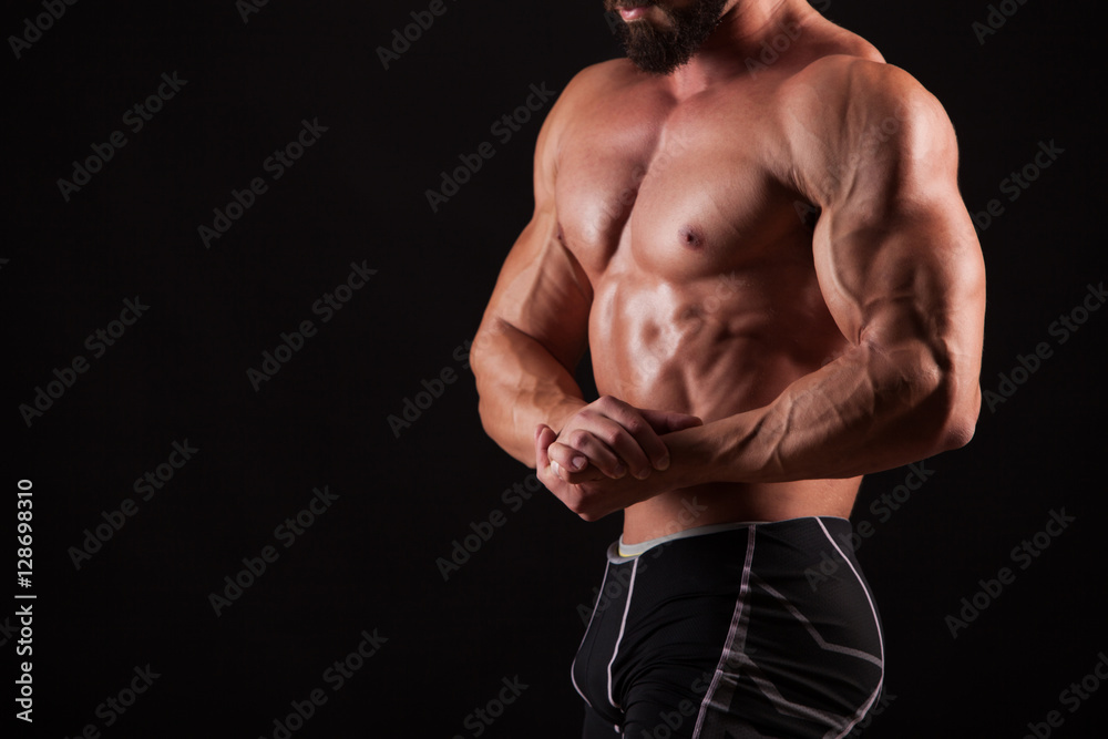 Handsome muscular bodybuilder posing over black background. Stock Photo ...