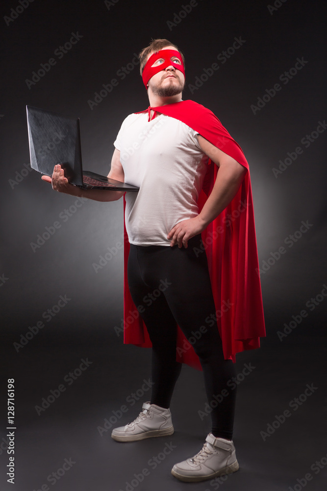 Super hero man ready to help your laptop computer. Handsome man with ...