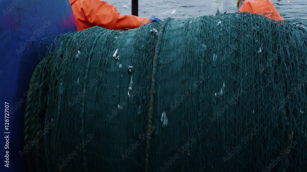 Crew of Fishermen Work on Commercial Fishing Ship that Pulls Trawl Net ...