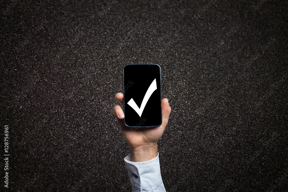 phone on hand and check mark on screen phone Stock Photo | Adobe Stock