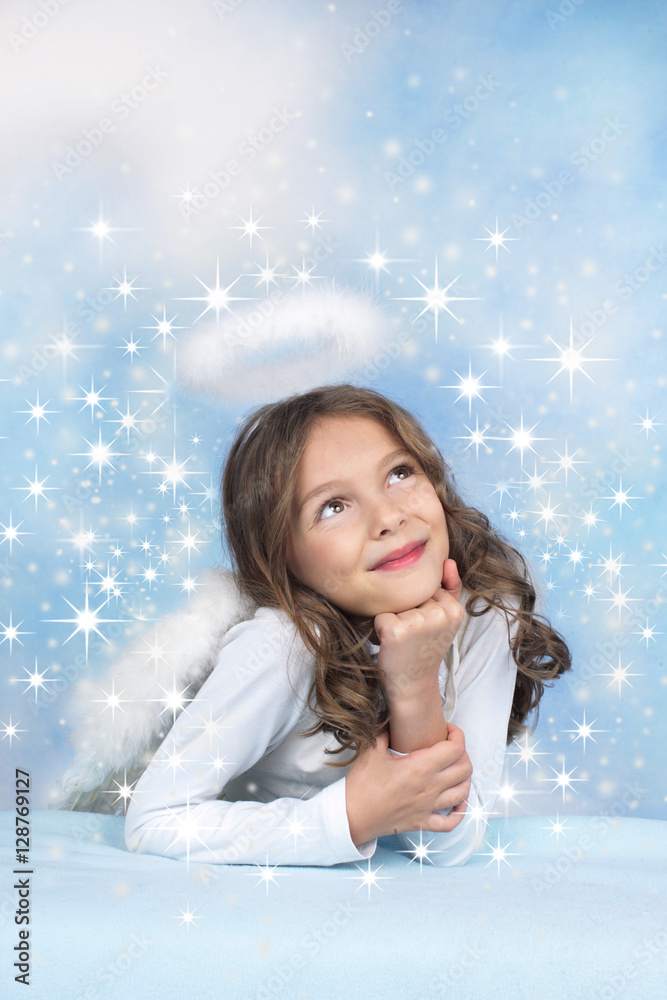 Cute little angel girl looking up Stock Photo | Adobe Stock