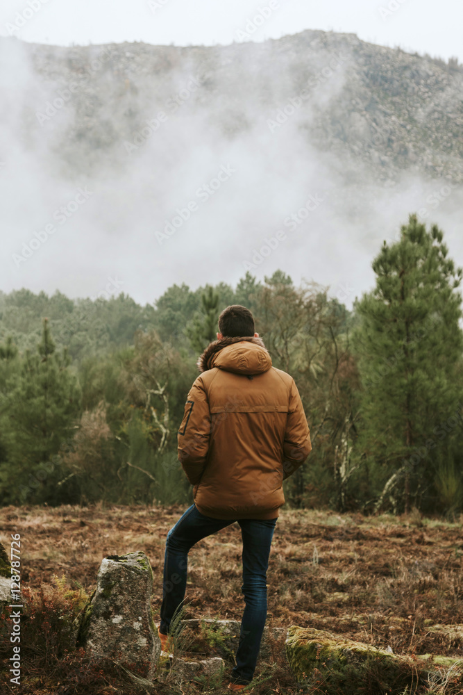 young man in the forest looking at the landscape Stock Photo | Adobe Stock