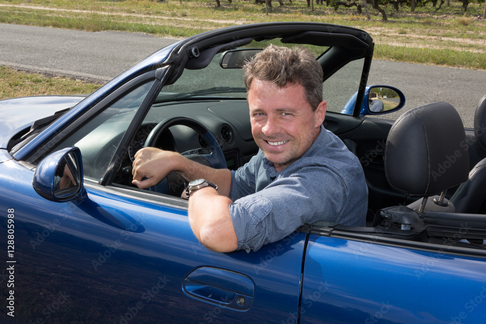 Fotografia do Stock: Middle aged man in a sports car | Adobe Stock