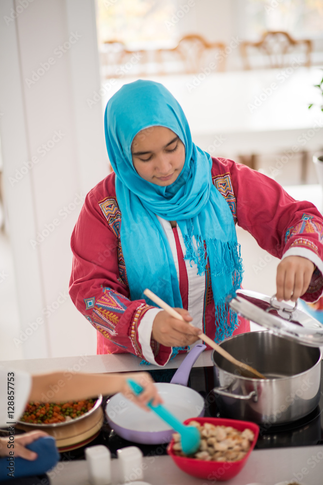 Muslim traditional young girl making food in kitchen Stock Photo ...