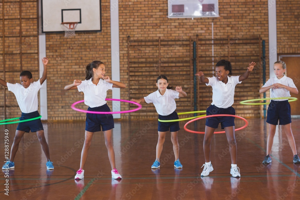 School kids playing with hula hoop in in basketball court Stock Photo ...