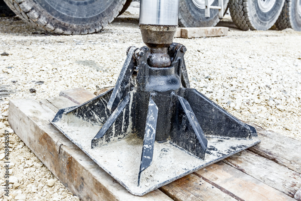 Hydraulic crane foot is supported by wood for safety, Lateral st Stock ...