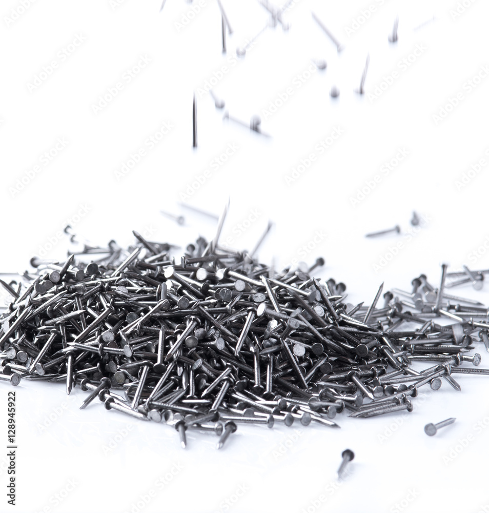pile of metal nails on a white background Stock Photo | Adobe Stock
