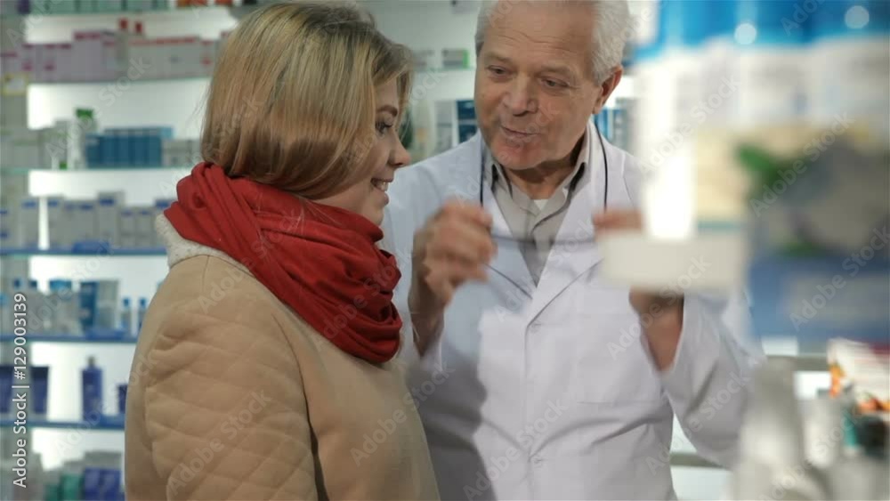 Senior male druggist consultated female customer at the drugstore. Aged ...