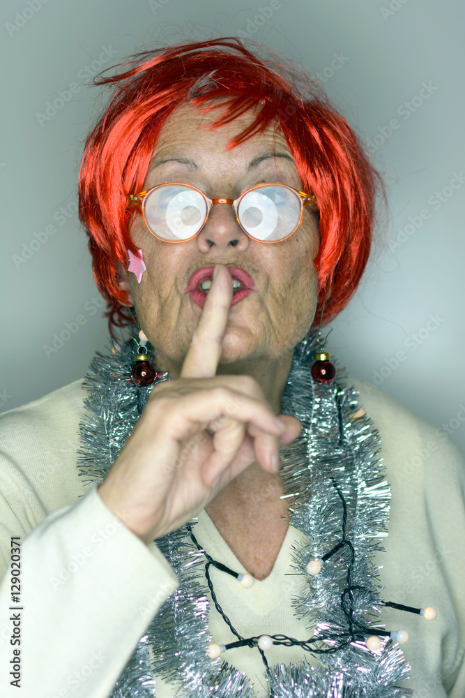 Closeup portrait, senior mature woman placing finger hand on lips, shhh ...