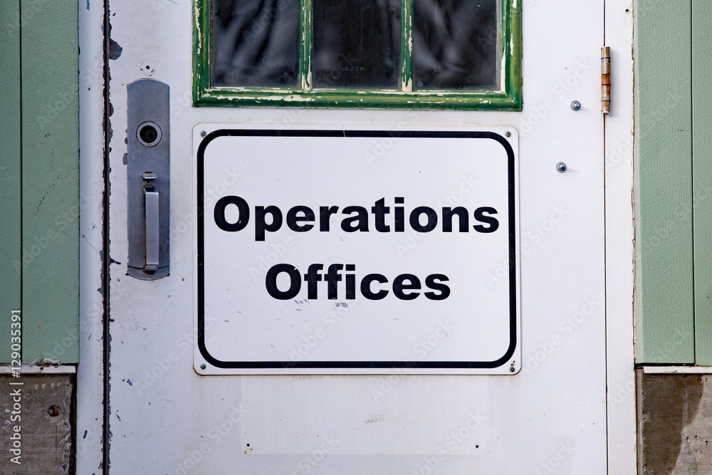 sign with the words operation offices on white background mounted on a ...