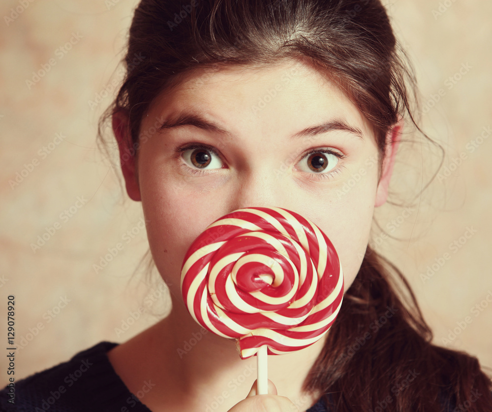 beautiful preteen girl with round candy Stock Photo | Adobe Stock