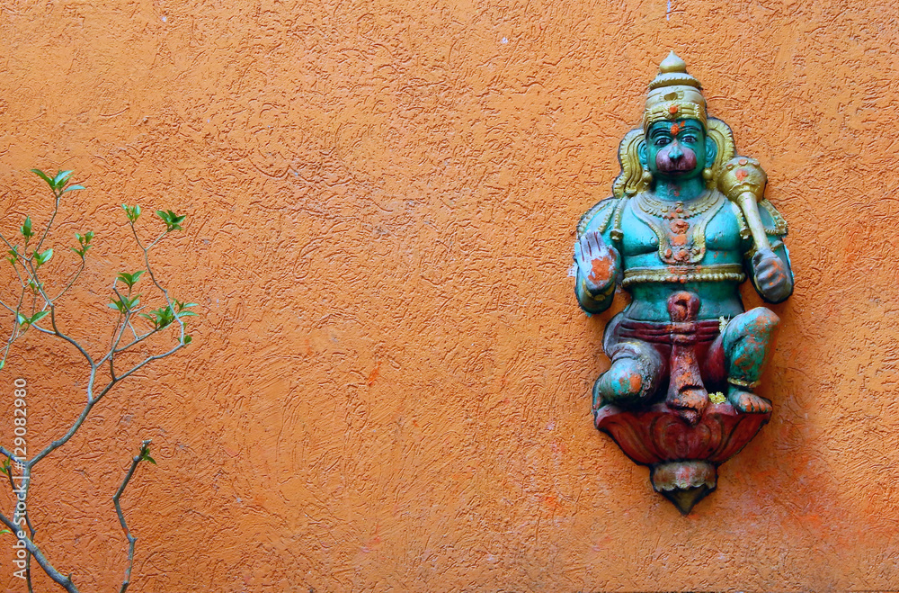 Hindu god Anjaneya or Hanuman sculpted on on wall of the temple as is ...