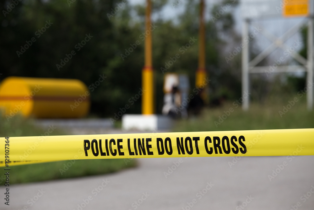 police line do no cross with gas station background in crime scene ...