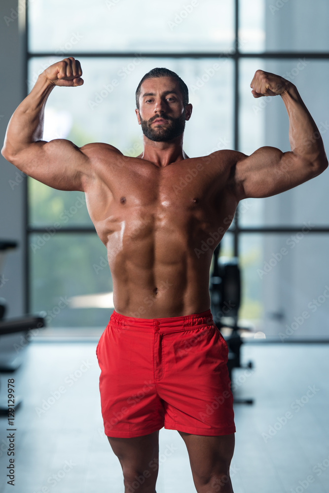 Bodybuilder Performing Front Double Biceps Pose In Gym Stock Photo ...