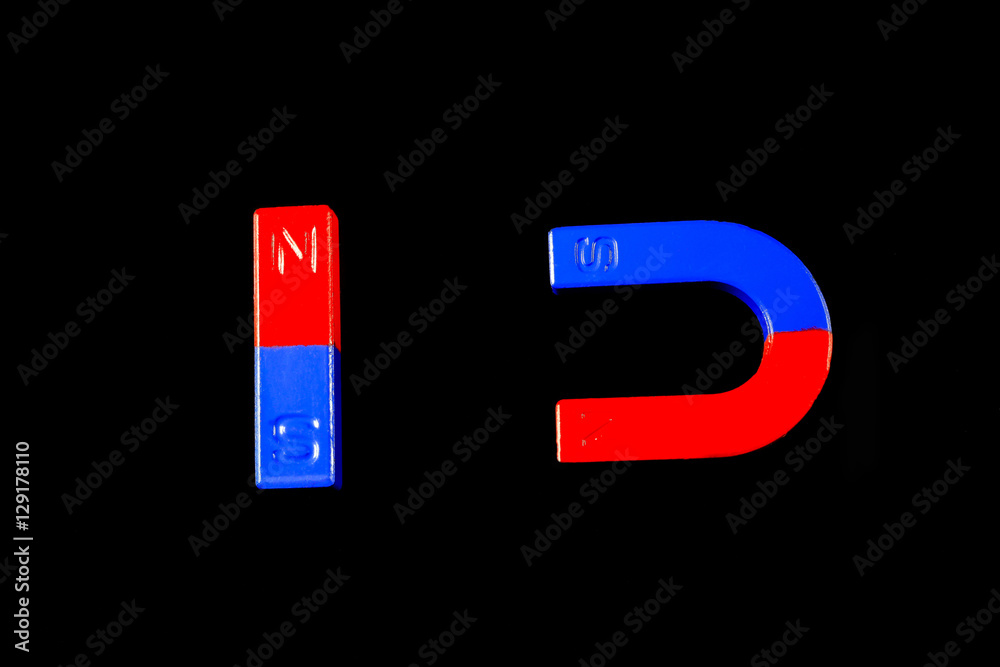 Magnetic red and blue on a black background. Stock Photo | Adobe Stock
