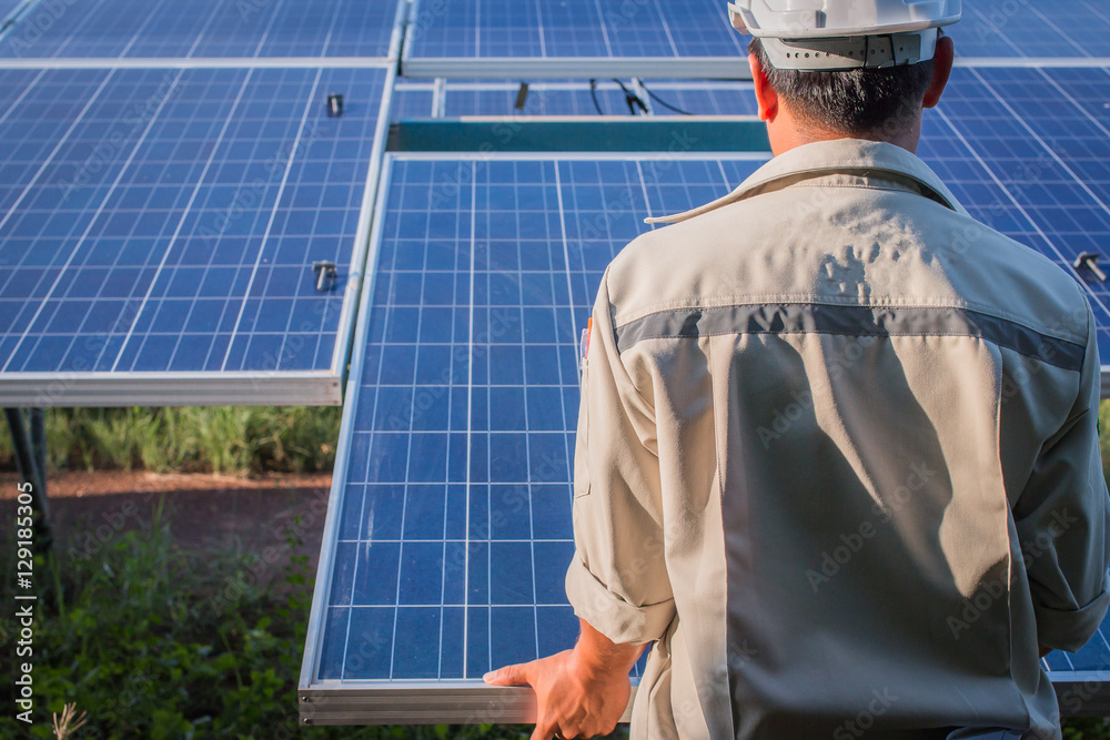engineer or electrician working on replacement solar panel in solar ...