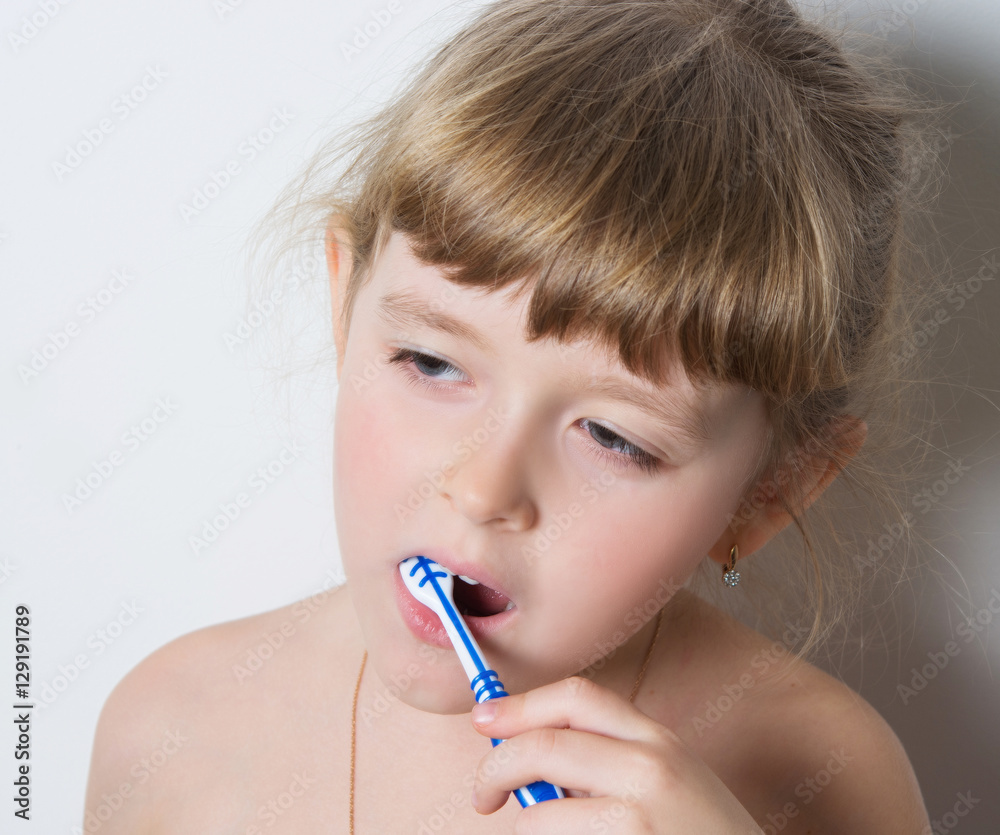 sleepy girl cleans teeth by brush Stock Photo | Adobe Stock