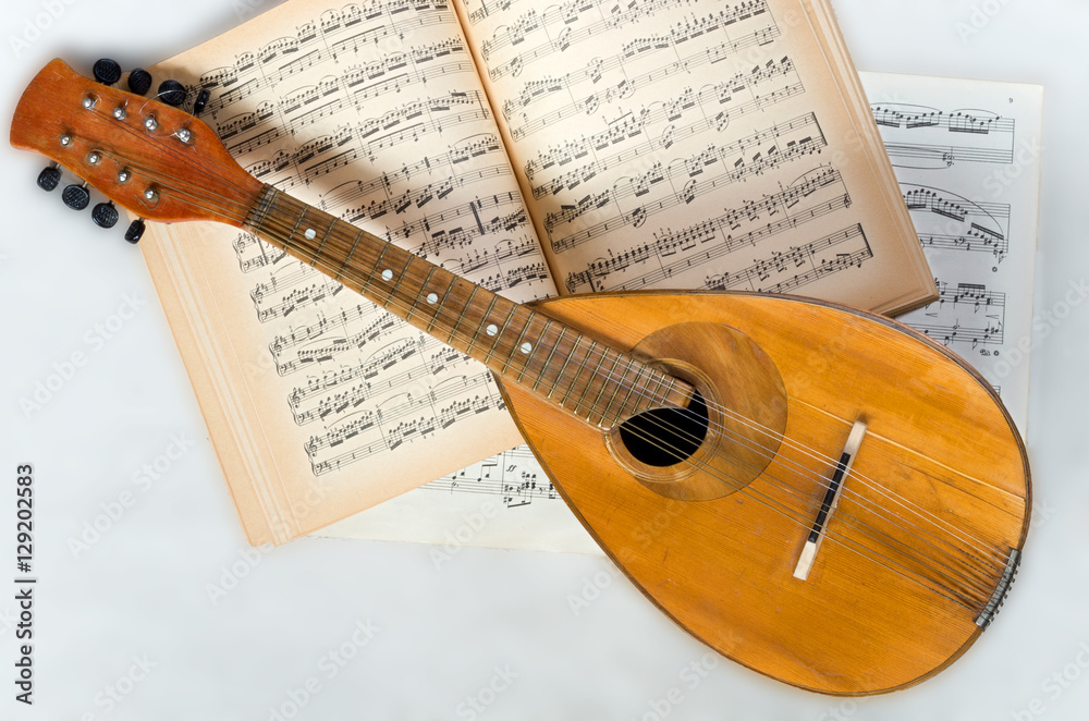 Old mandolin with music notes on a white background. Stringed musical ...