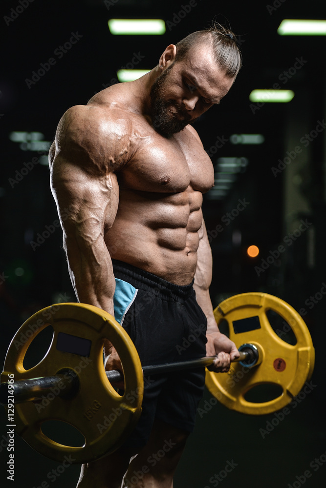 Brutal strong bodybuilder athletic men pumping up muscles with d Stock ...
