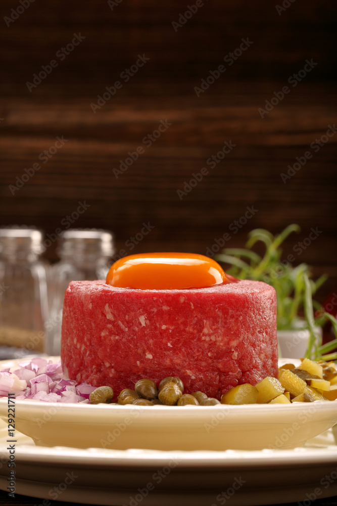 Beef tatare with egg, onion, cucumber and capers Stock Photo | Adobe Stock