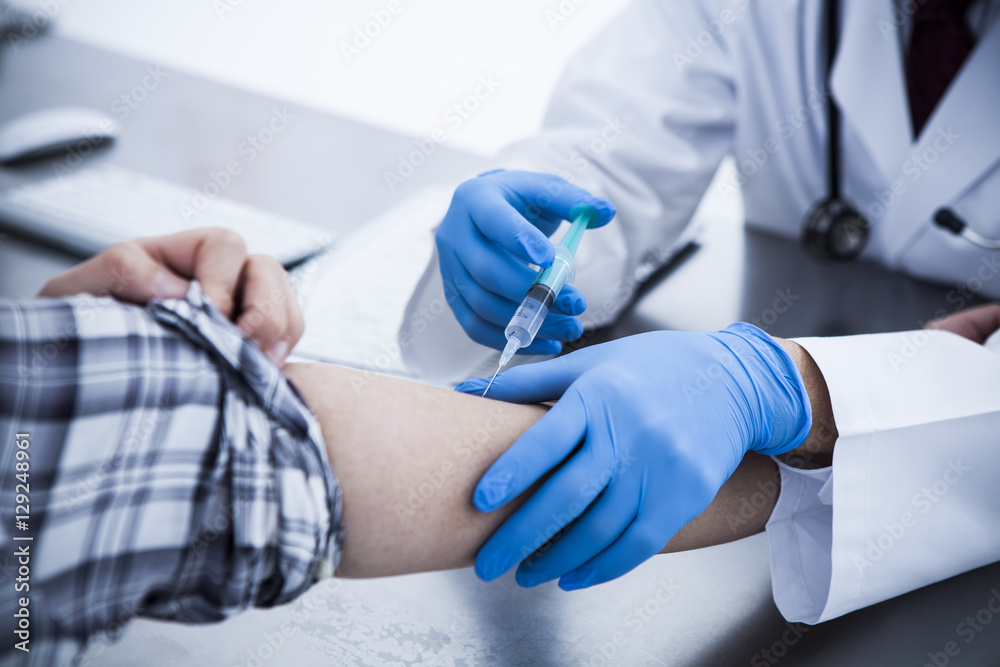 Men are given an injection in their arms Stock Photo | Adobe Stock