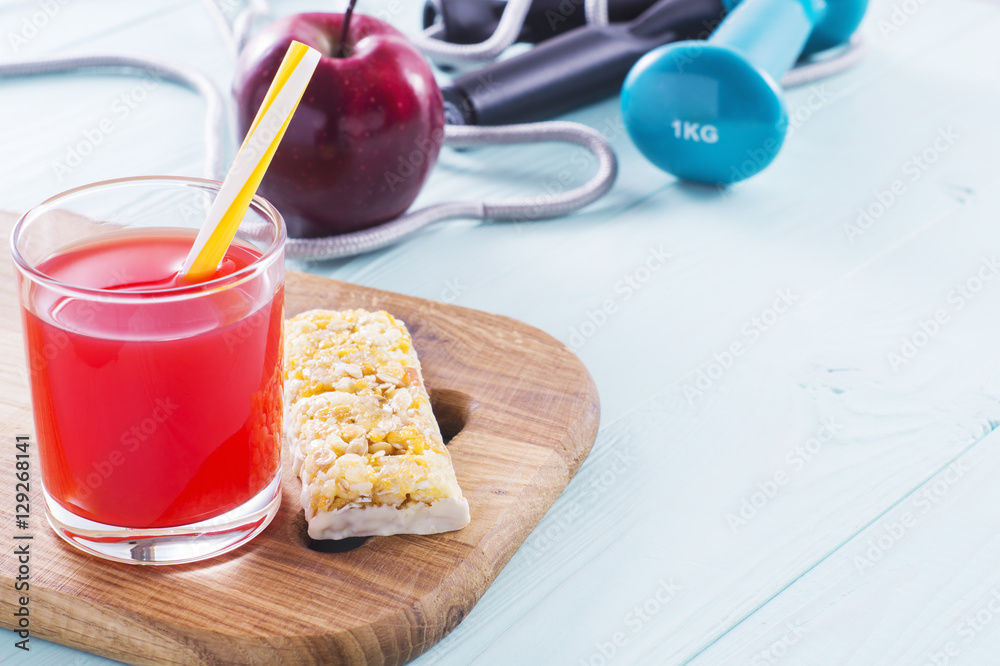 The concept of weight loss, jump rope, juice, cereal bar and red apple ...