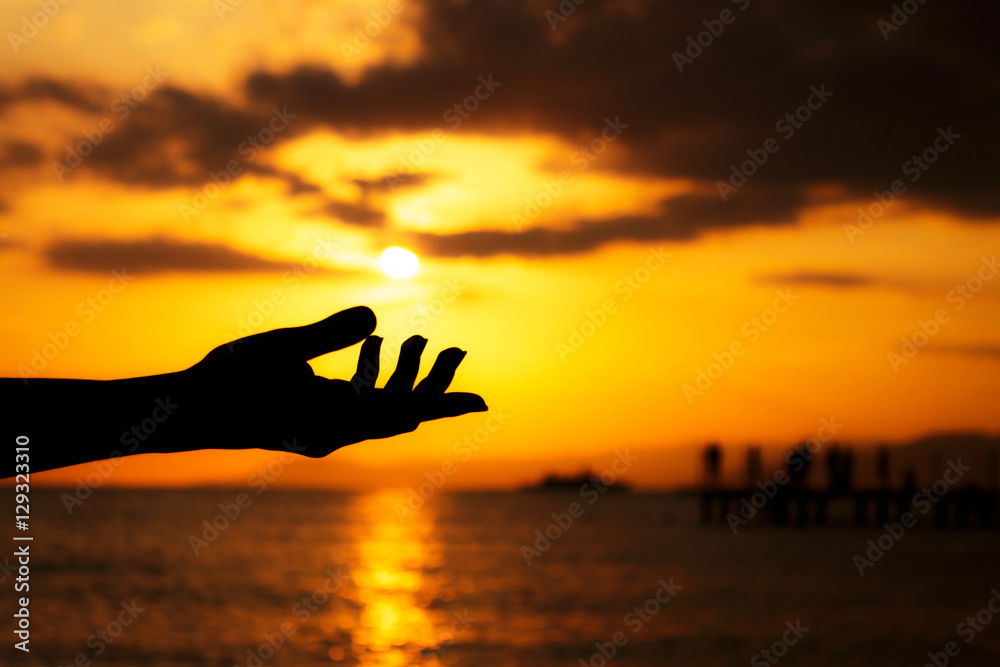 Hand holding the sun - sunset capture with a silhouette of a woman's ...