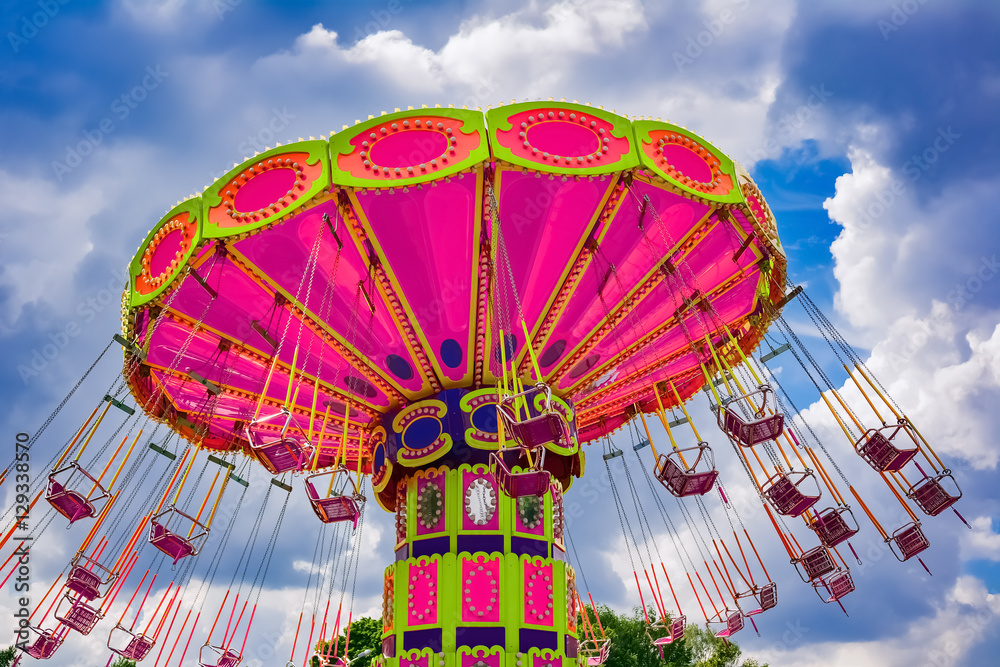 Colorful flying swing ride in motion at the amusement park Stock Photo ...