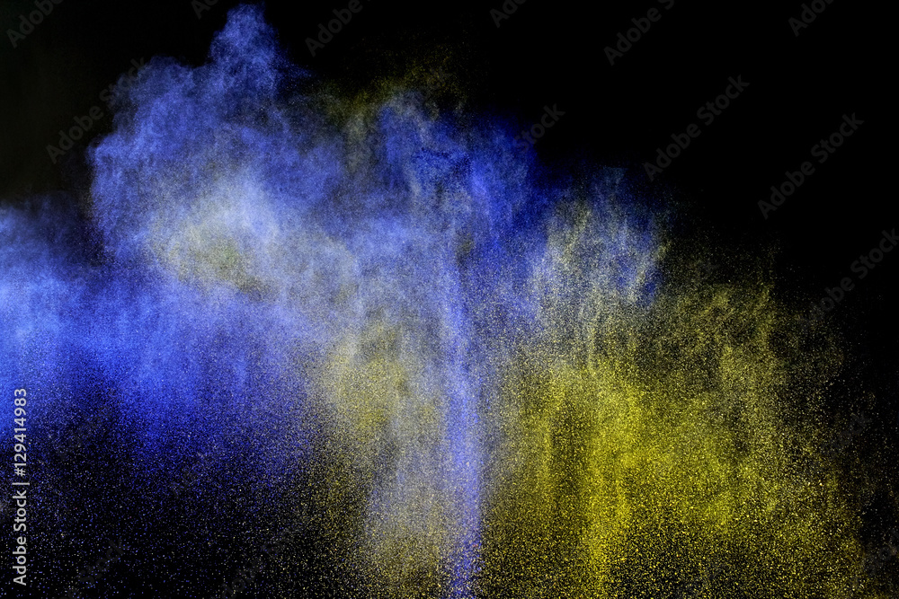 abstract of blue and yellow powder explosion on black background Stock ...