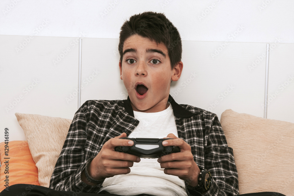 child with the remote control of the video game console playing ...