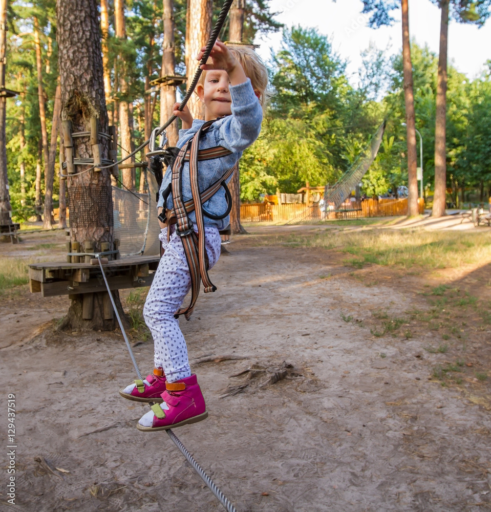 Little girl overcomes obstacles. / Three-year girl the blonde with a ...