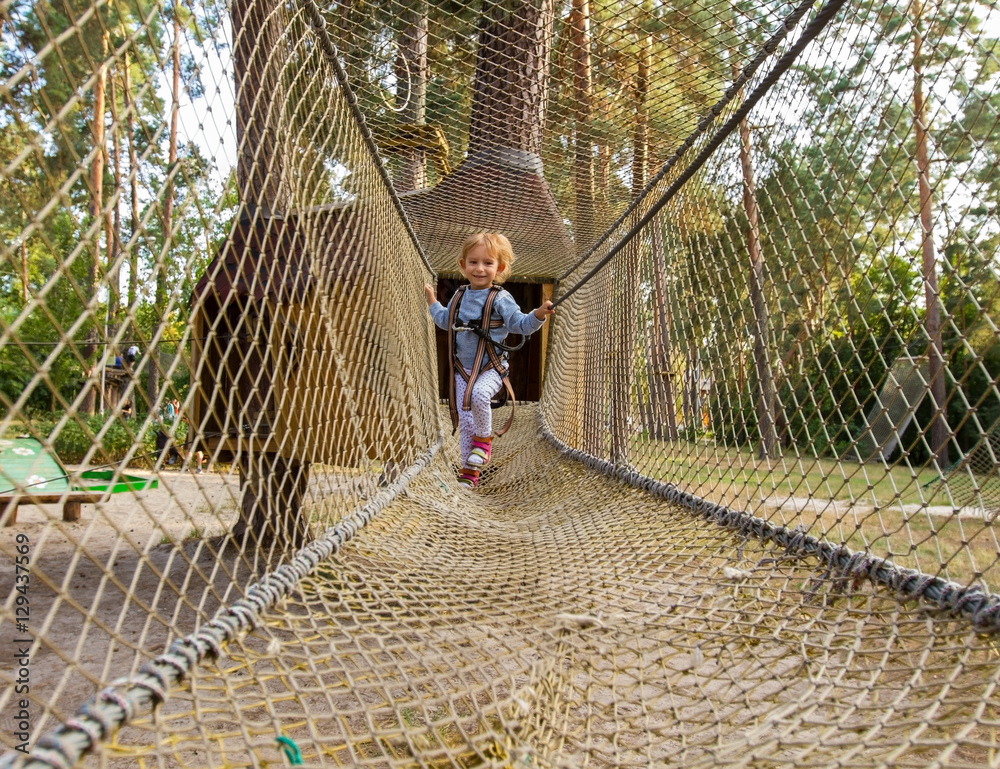 Little girl overcomes obstacles. / Three-year girl the blonde with a ...