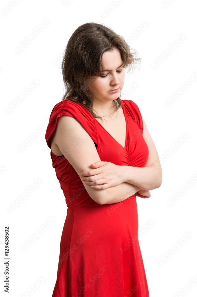 Young sad woman in red dress on white background. Stock Photo | Adobe Stock